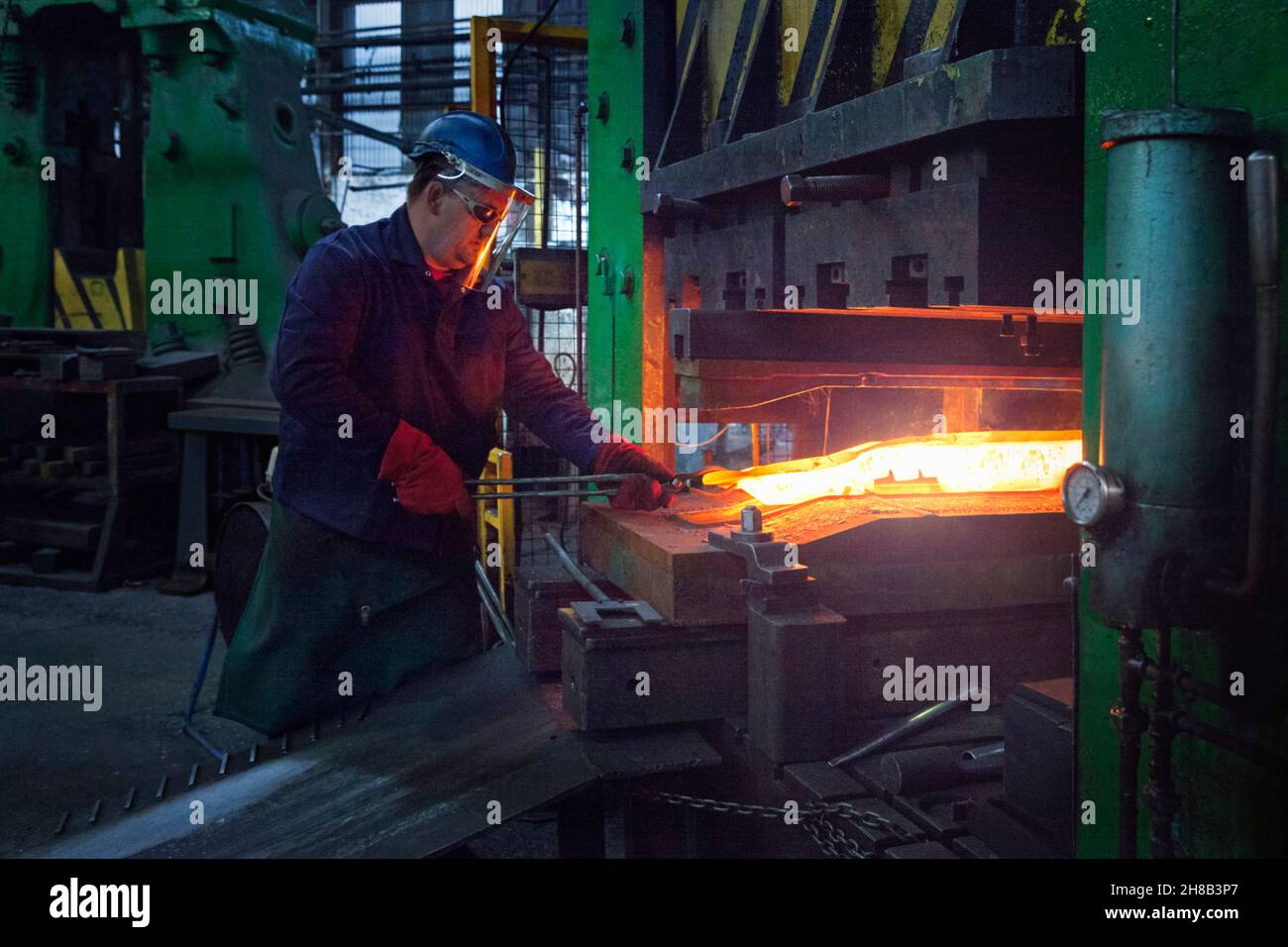 Flight bar is moved out of the clipping press where excess "flash" has ...