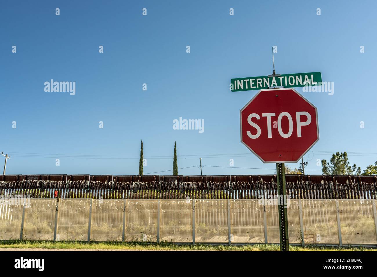 Stop sign and International Avenue street sign in front of the Mexico ...