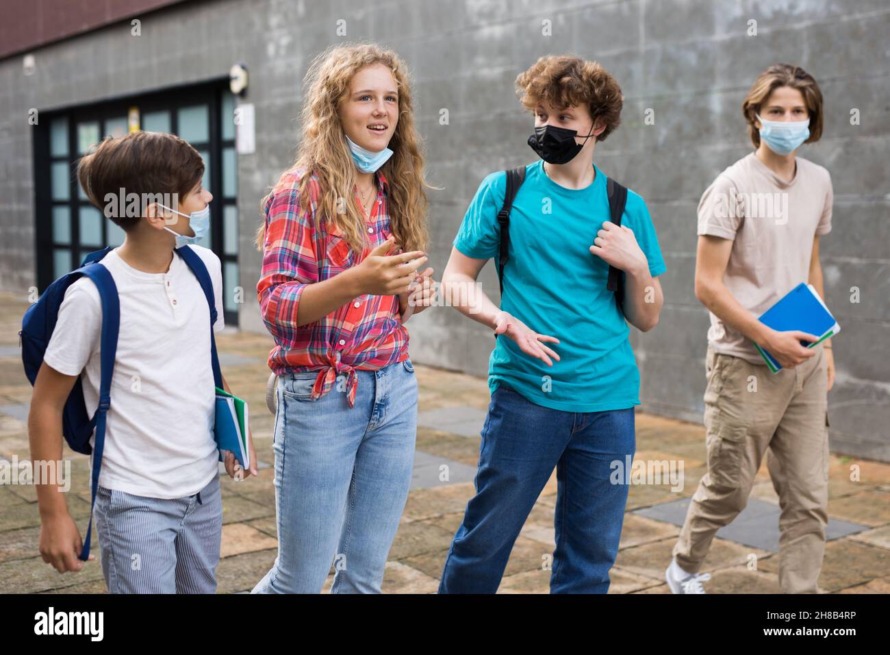 Teenagers in masks walking in school campus Stock Photo - Alamy