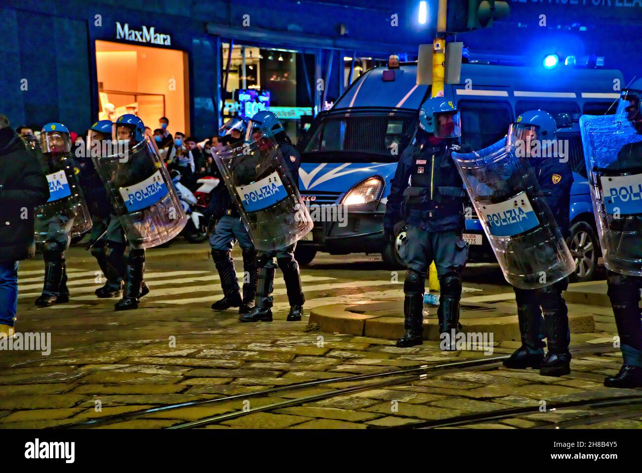 police officers in riot uniforms with shields move to quell a ...
