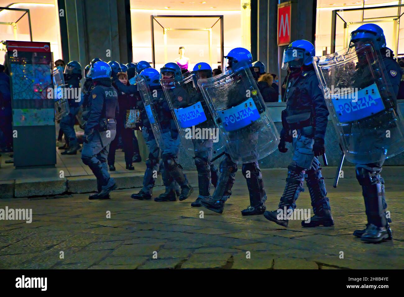 police officers in riot uniforms with shields move to quell a ...