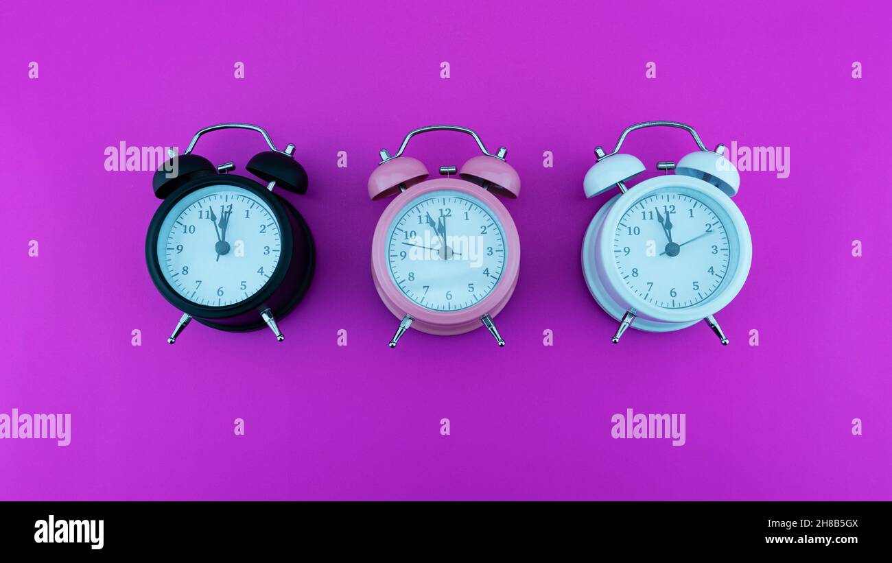 Beautiful three Alarm Clock on colorful paper Background Alarm Clock ...