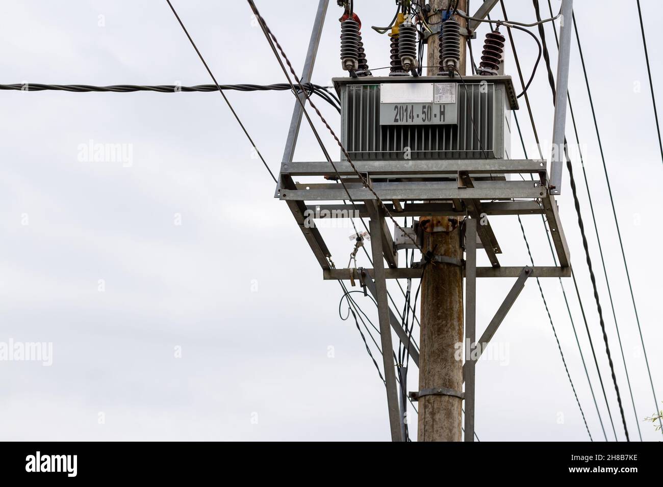 A transformer with concrete poles is used to distribute electric ...