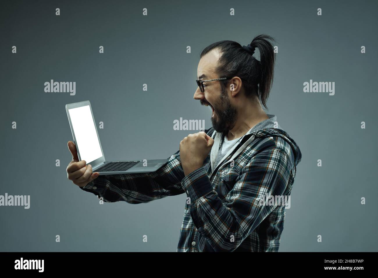 Exuberant ecstatic man exclaiming - OMG I've won! - as he pumps the air ...