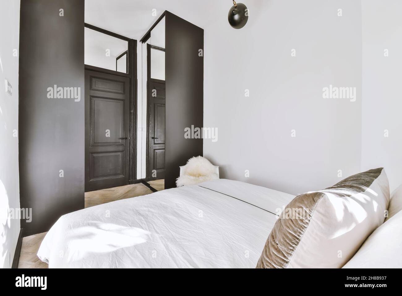 Small cozy bedroom with contrast on black Stock Photo - Alamy