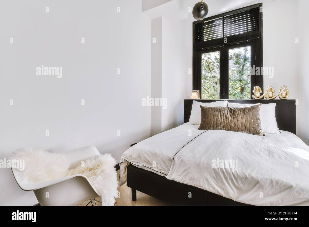 Small cozy bedroom with contrast on black Stock Photo - Alamy
