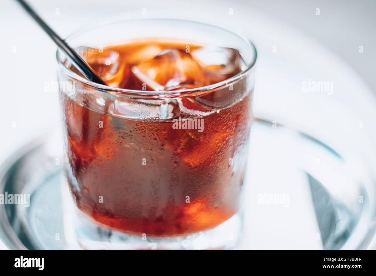 Cold brew with full of ice and black straw on a white background ...