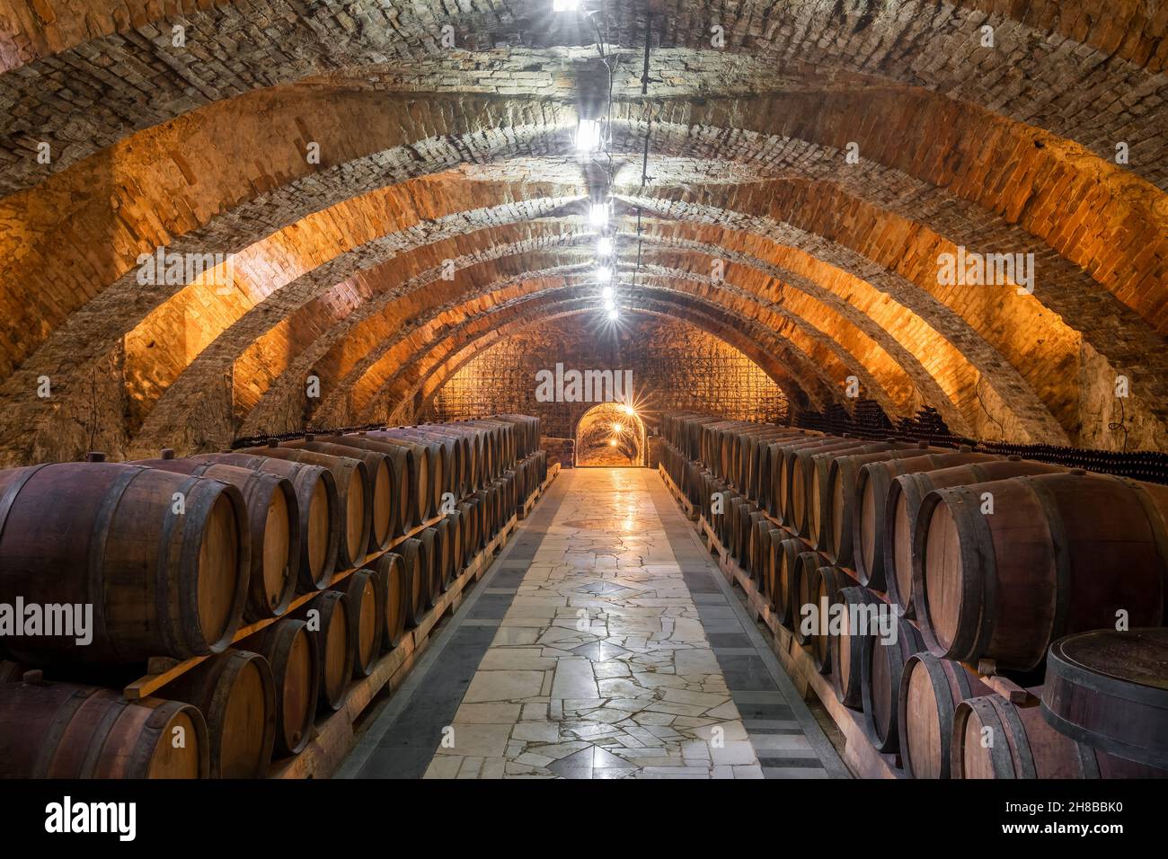 Old wooden barrels with wine in the ancient medieval cellars Stock ...