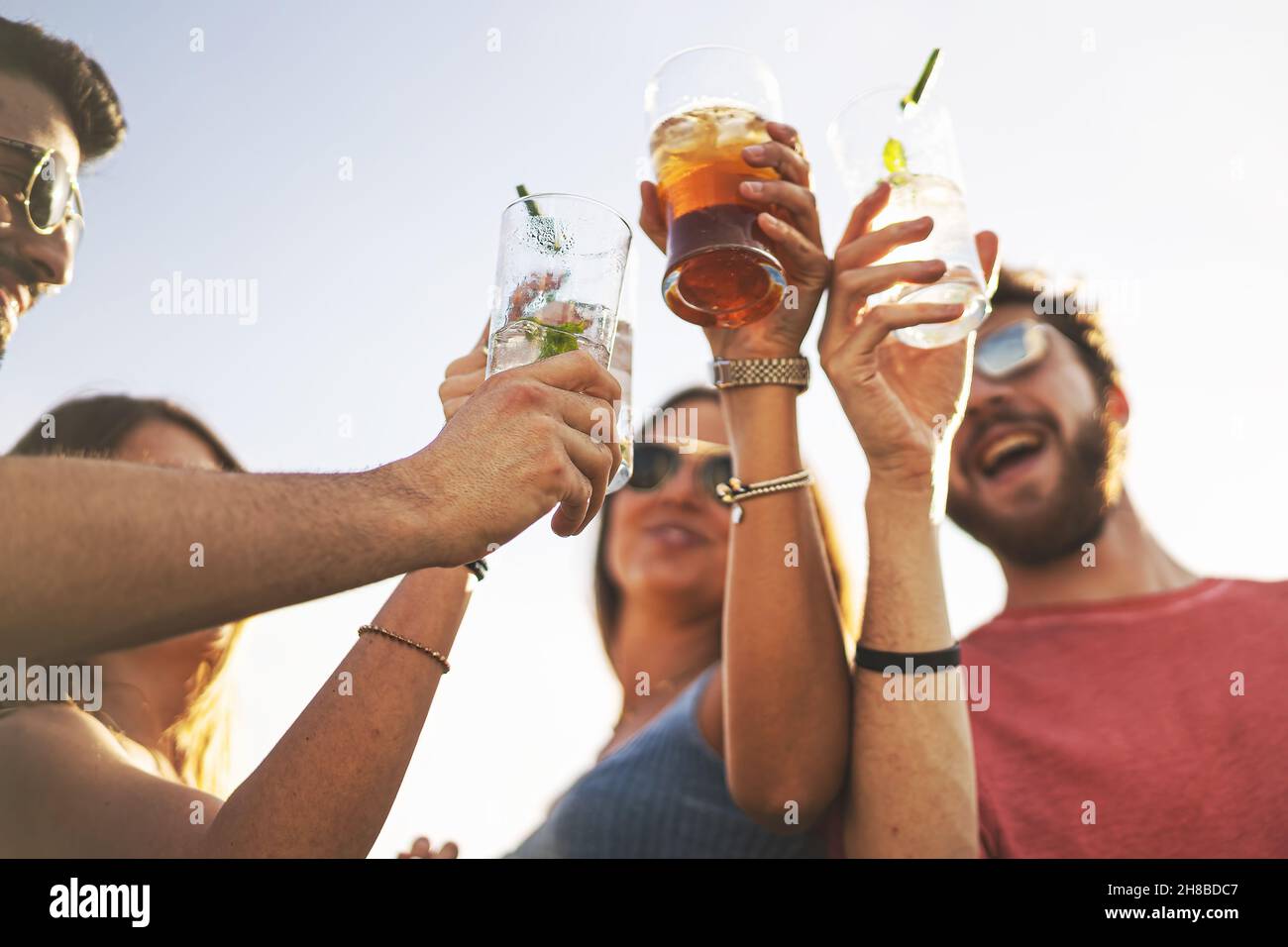 Friends Clinking Alcoholic Cocktail Glasses Together Carefree Young