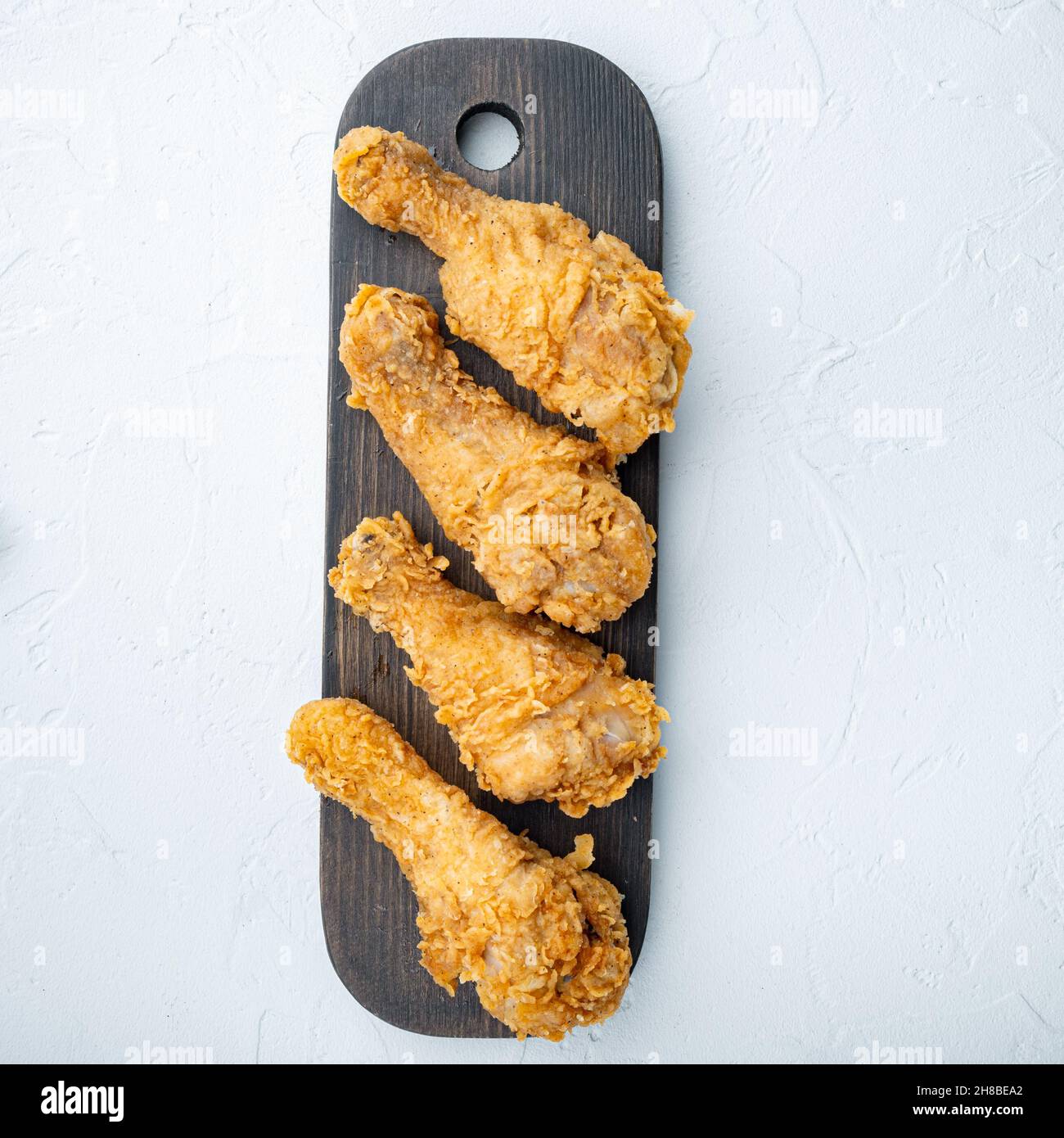 Chicken leg breaded and fried on white background Stock Photo - Alamy