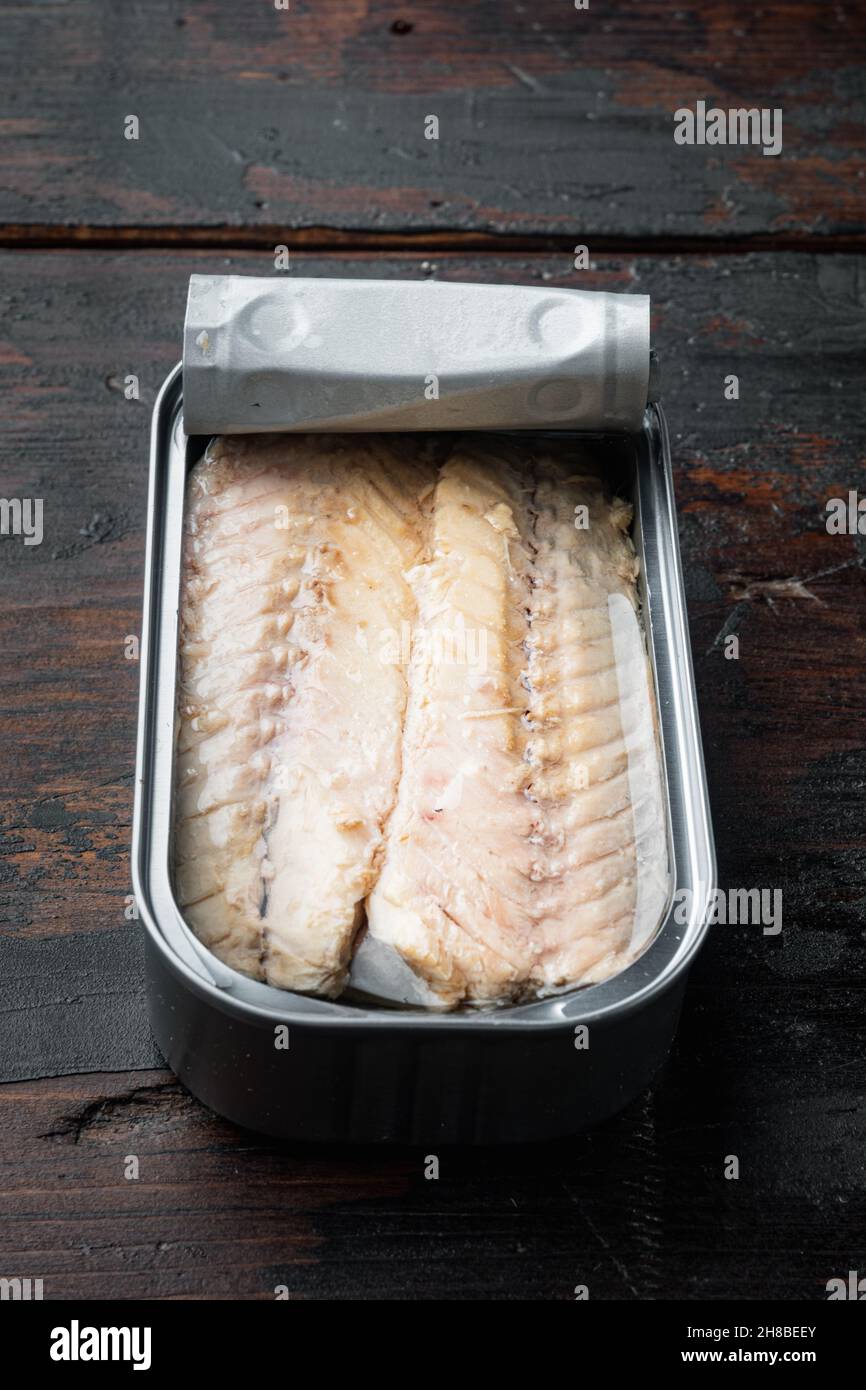 Canned Mackerel Fillets in Tin set, in tin can, on old dark wooden ...