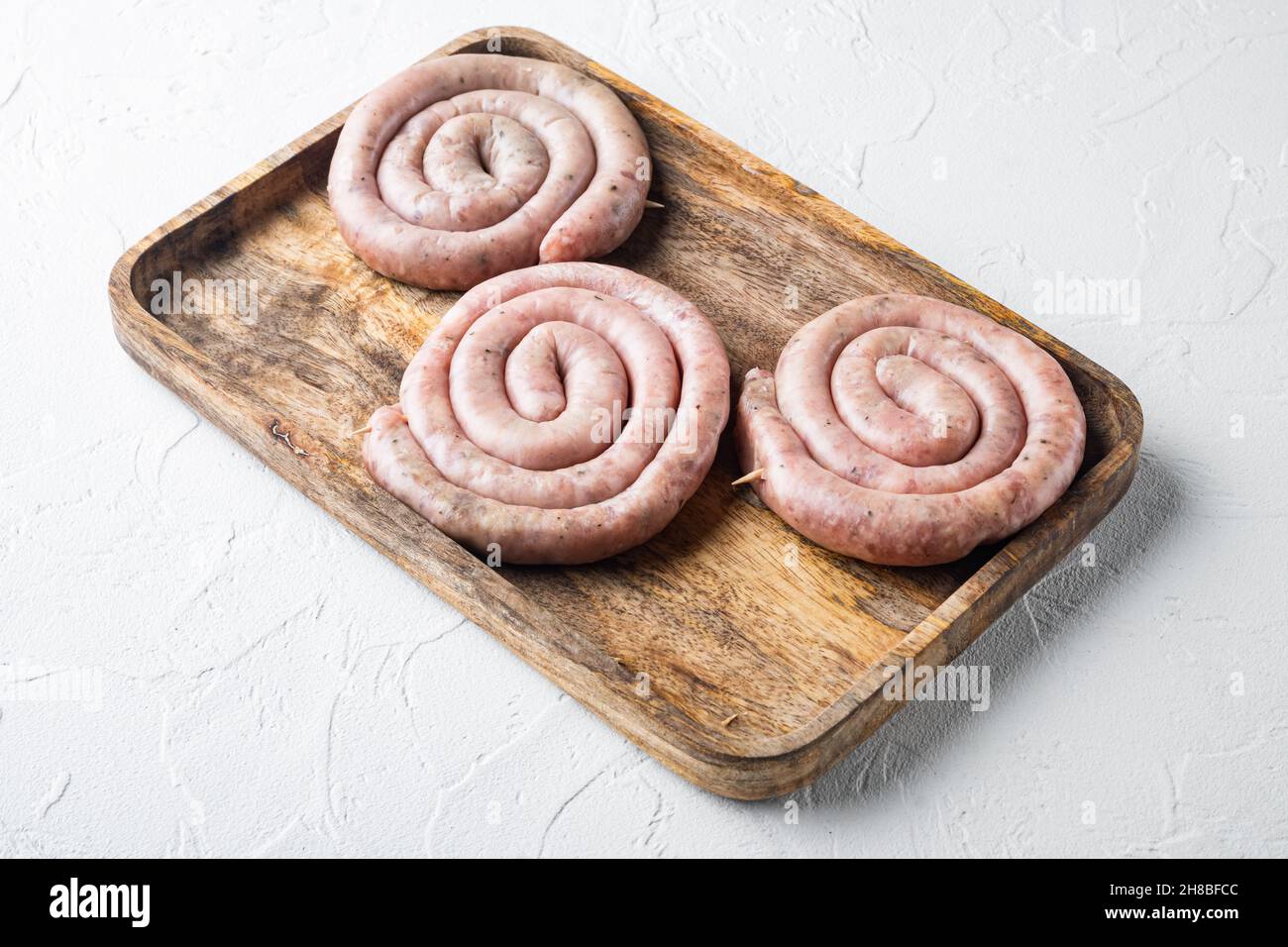 Raw snail sausage in traditional spiral set, on white background Stock ...