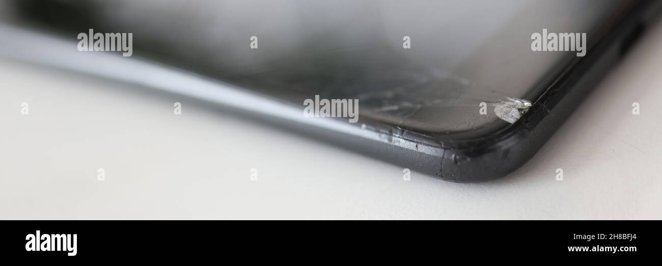 Smartphone with broken front screen is lying on table closeup Stock ...