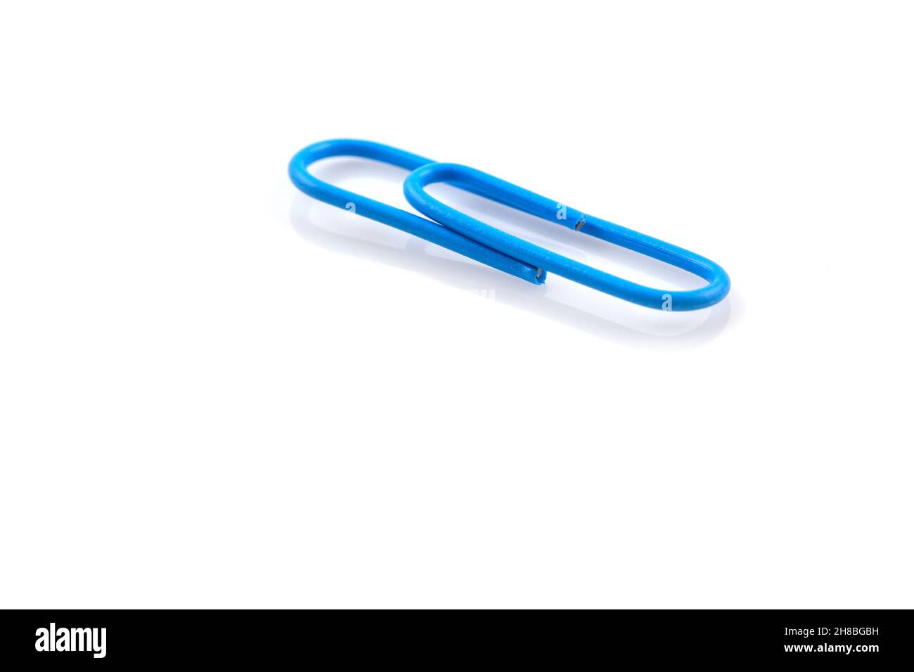 Single Blue paper clip isolated on white background Stock Photo - Alamy