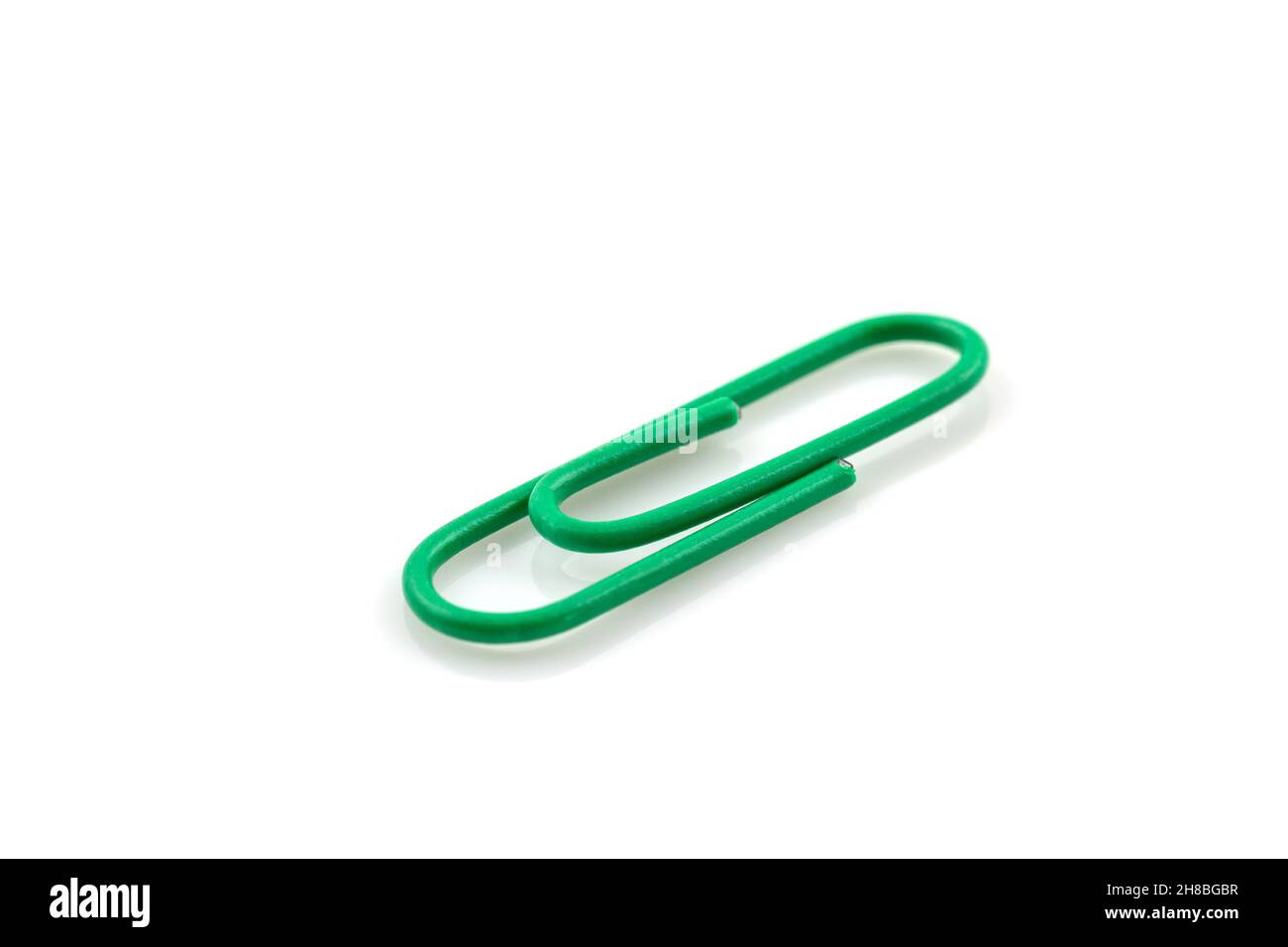 Single Green paper clip isolated on white background Stock Photo - Alamy