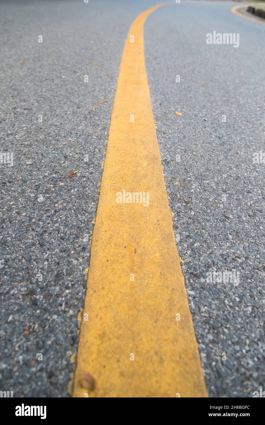 Close up of yellow line on the public park with people exercise and ...