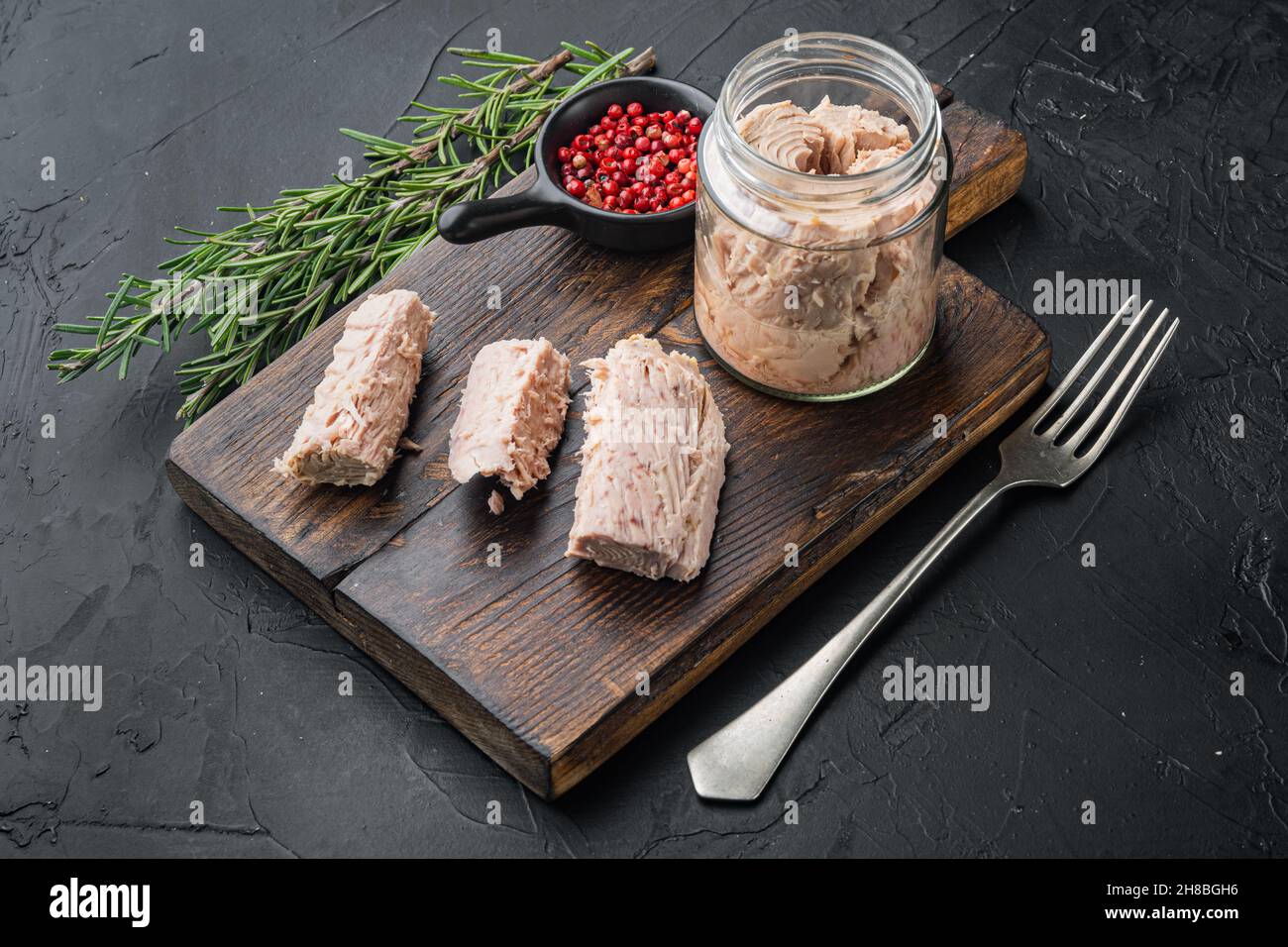 Canned tuna fillet meat in olive oil, on black background Stock Photo ...