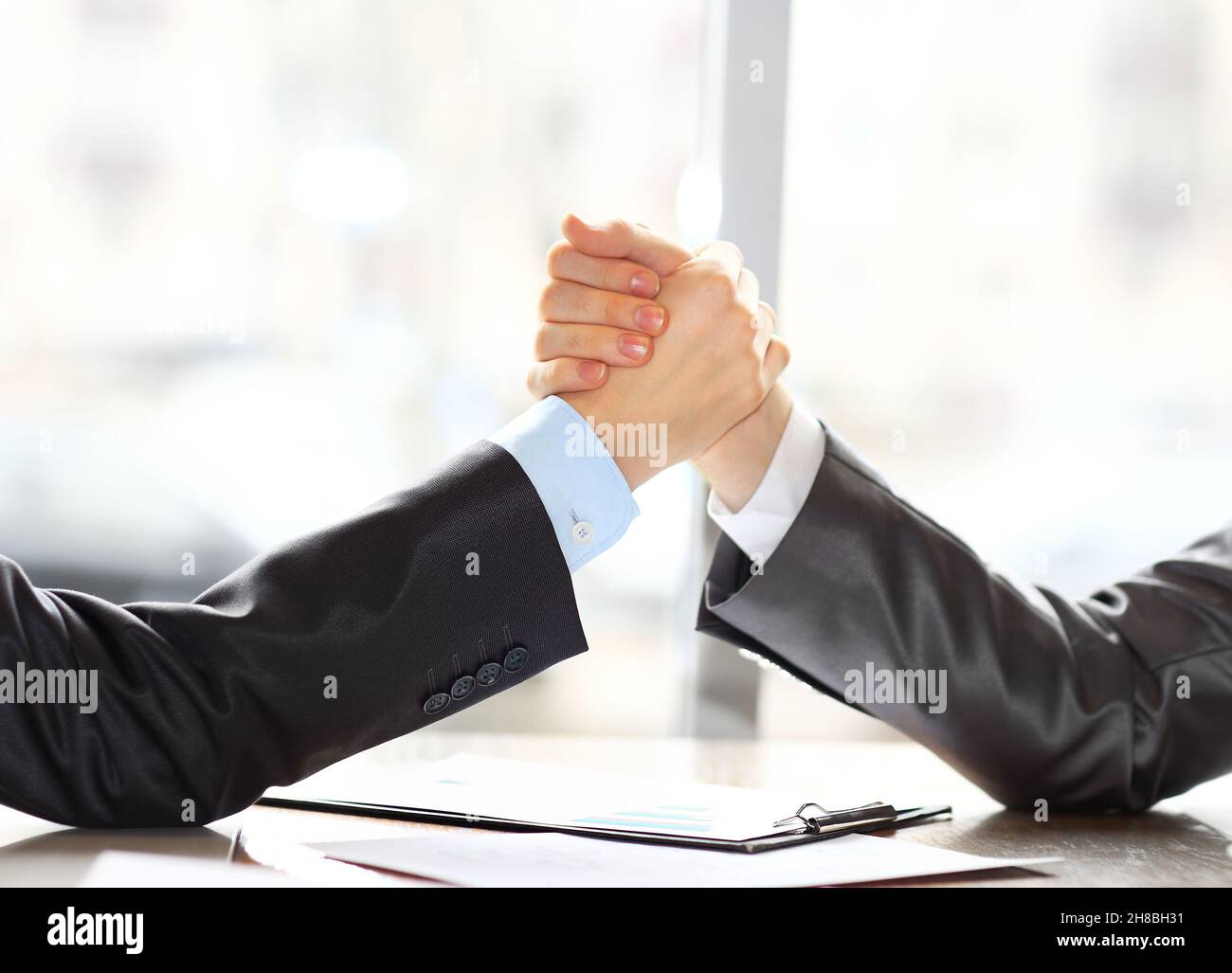 Two businessmen press hands each other on a forward background Stock ...