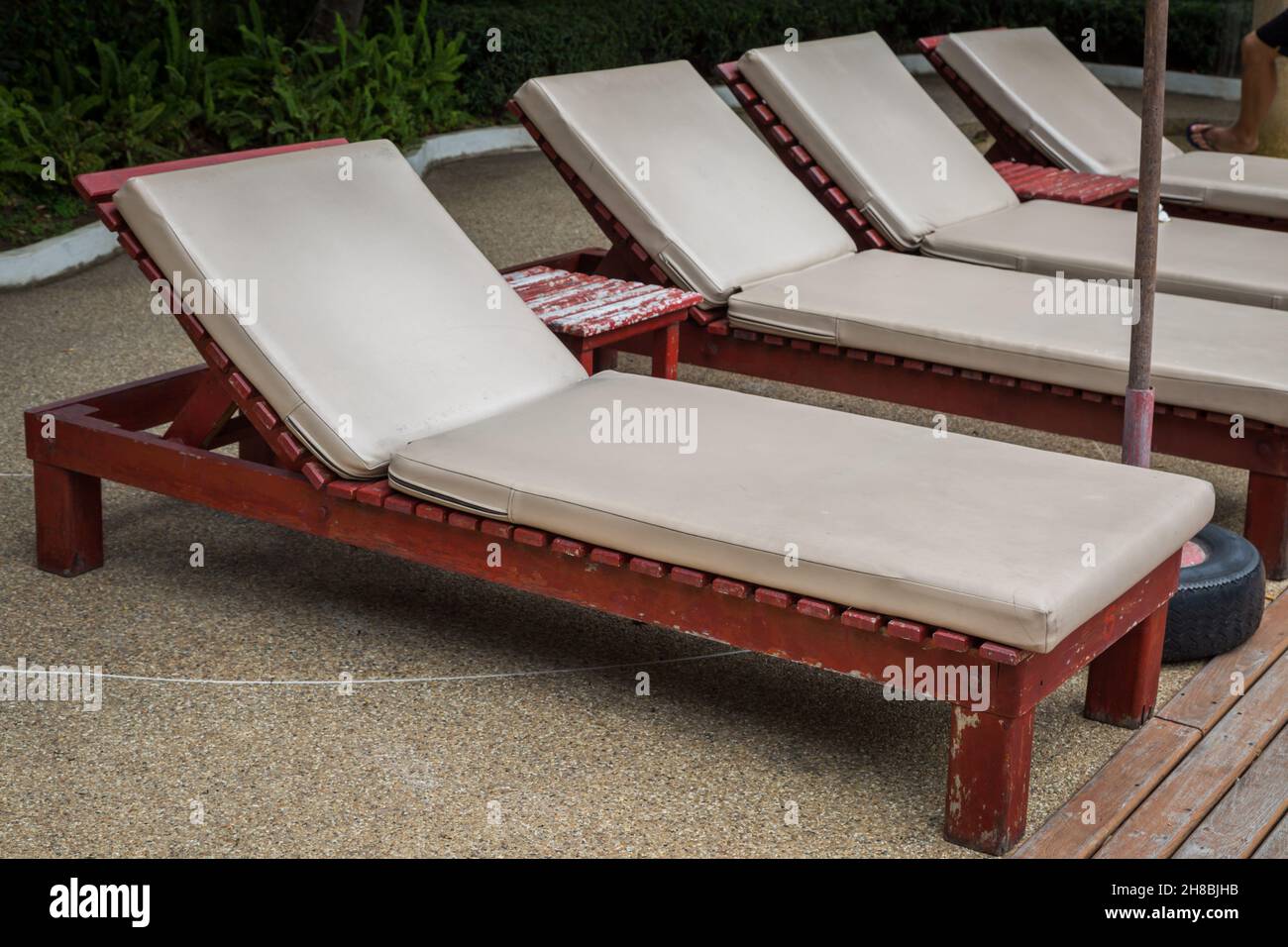 Pool chair side of swimming pool background Stock Photo - Alamy