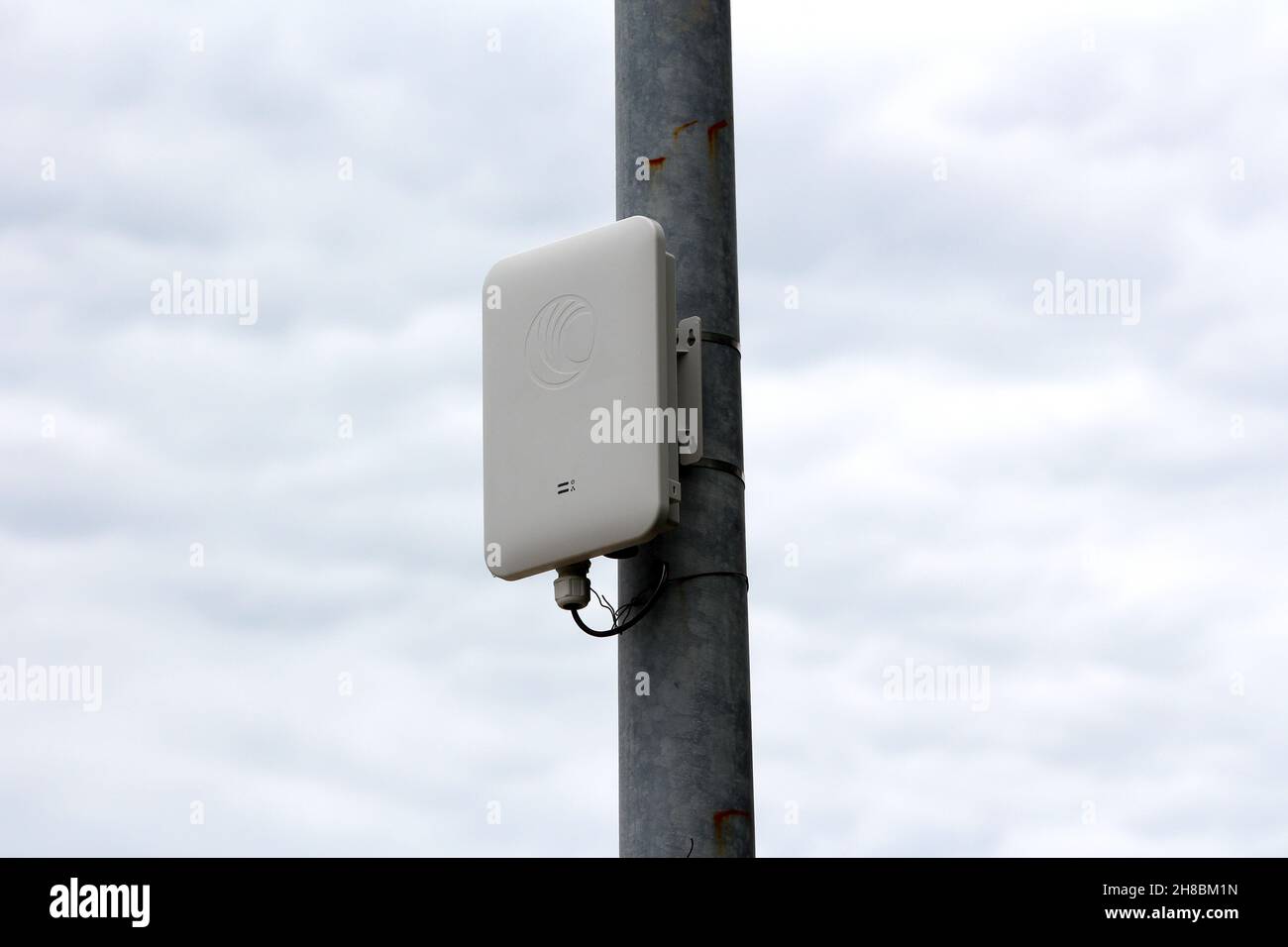 Modern new wireless communication device in white plastic case tied ...