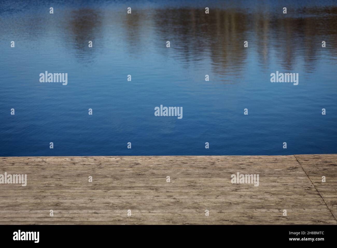 Wooden pier with blue sea and water background Stock Photo - Alamy