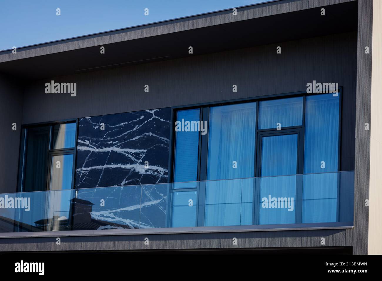 New house with balcony, big windows. Luxury cottage Stock Photo - Alamy