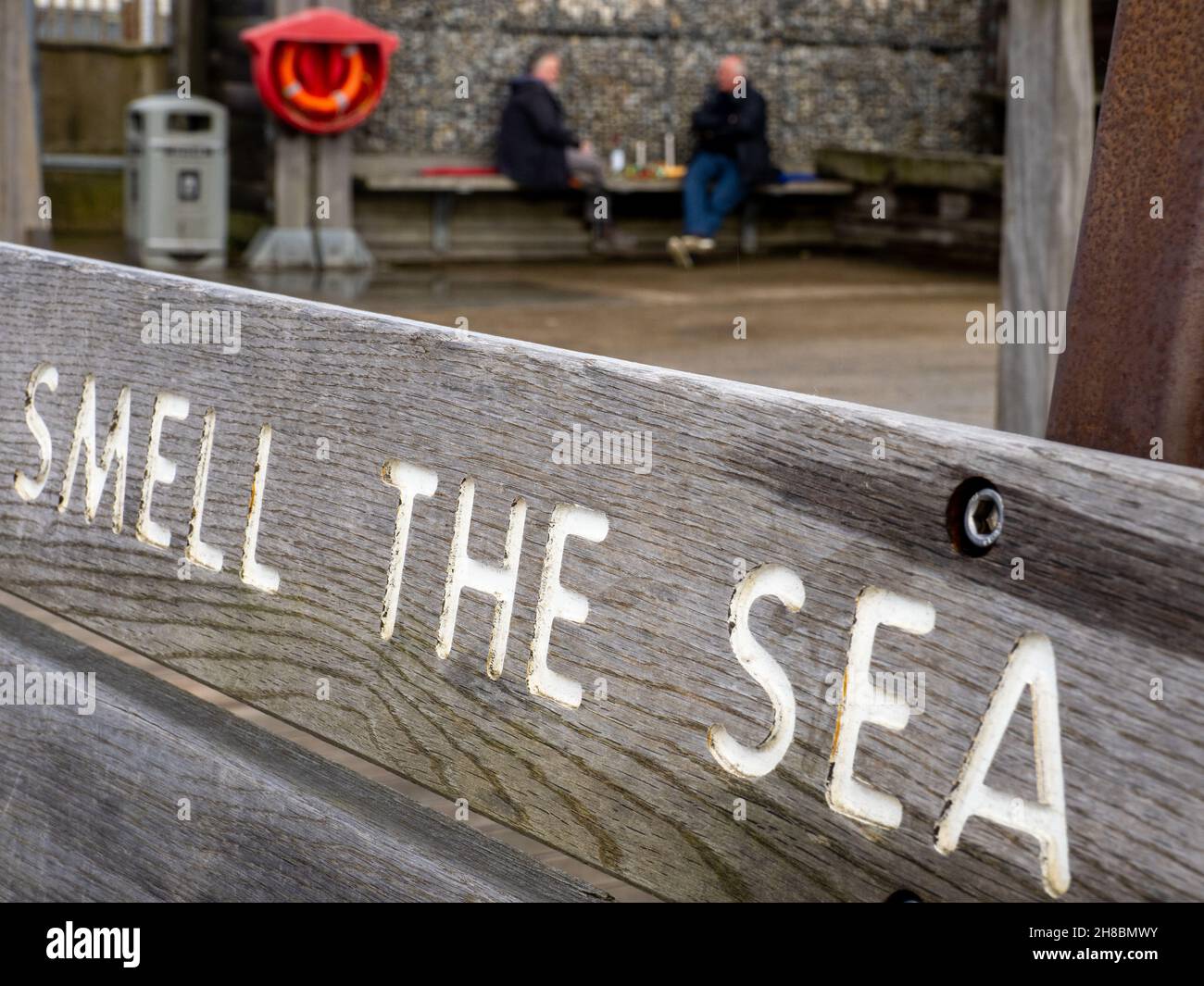 SMELL THE SEA: A couple have a picnic on a bench in Whitstable, Kent ...