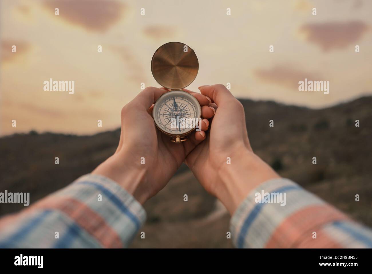 Female hand holding compass hi-res stock photography and images - Alamy