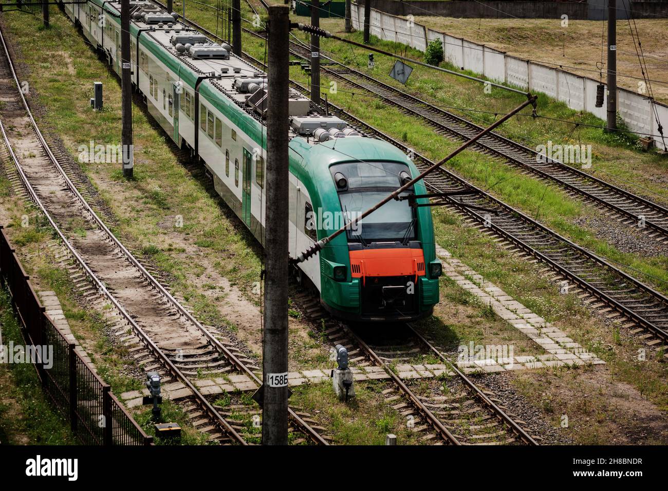 Modern high speed commuter train. Train at railway platform. Industrial ...