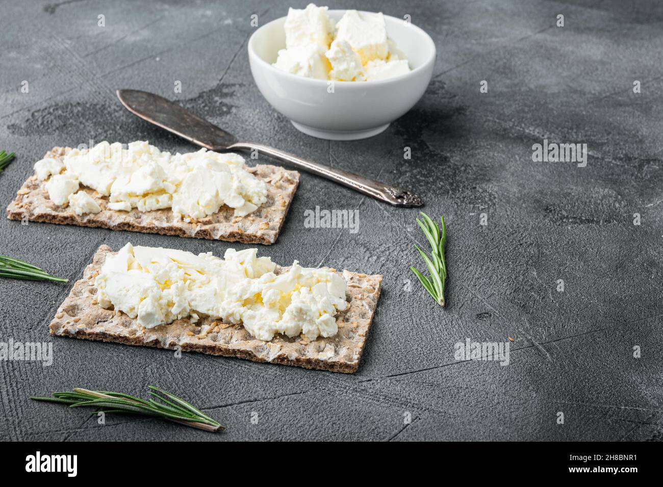 Fresh rye crispbreads with different topping set, on gray stone table ...