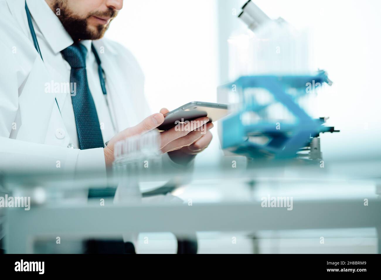 scientist reading his notes in a digital tablet Stock Photo - Alamy
