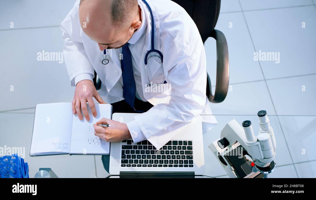 top view. lab scientist using a laptop to save data Stock Photo - Alamy
