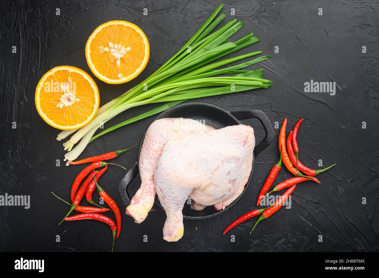 Raw meat. Chicken legs, drumsticks cuts set, with orange and chili, on ...