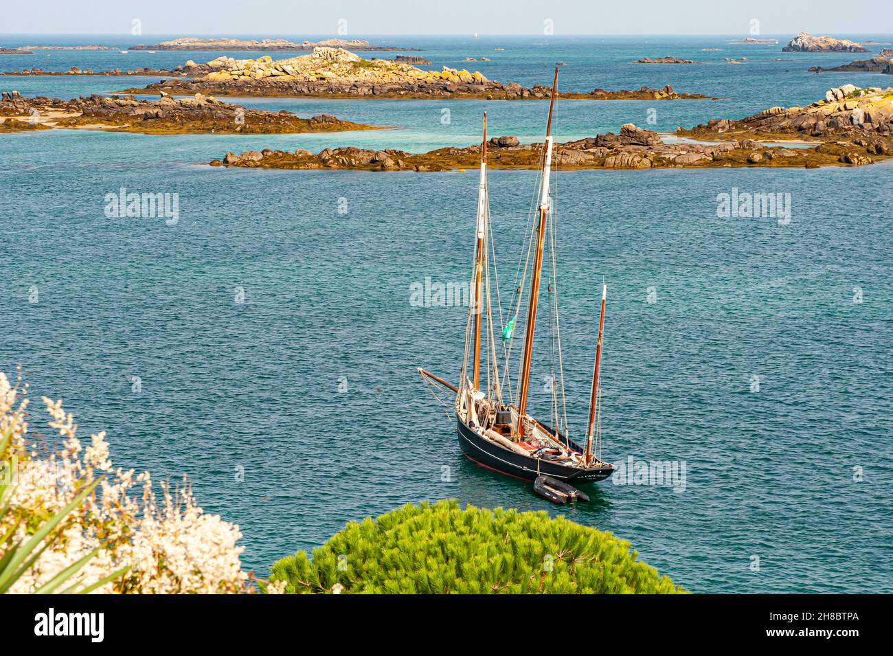A three-mast barque mooring in the waters of Grande-Île, the main ...