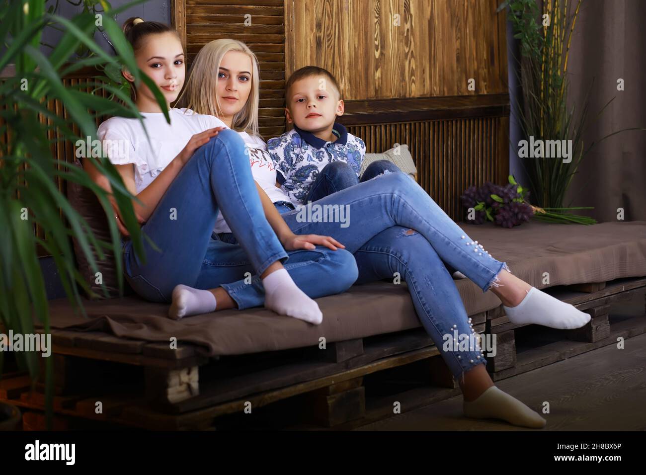 Funny active family of young adult parents and cute small children ...