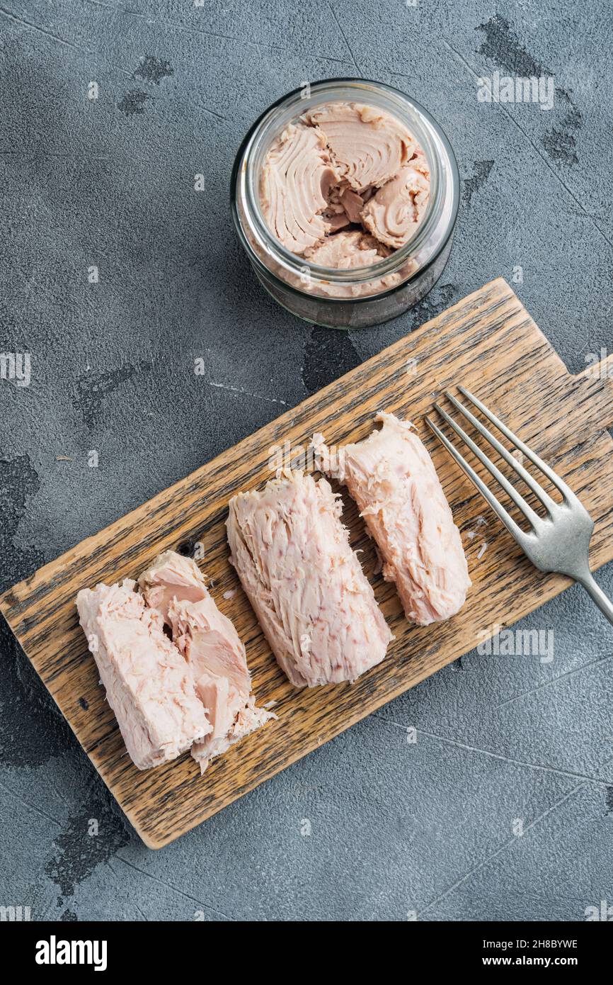 Canned tuna fillet meat in olive oil, on gray background, flat lay ...
