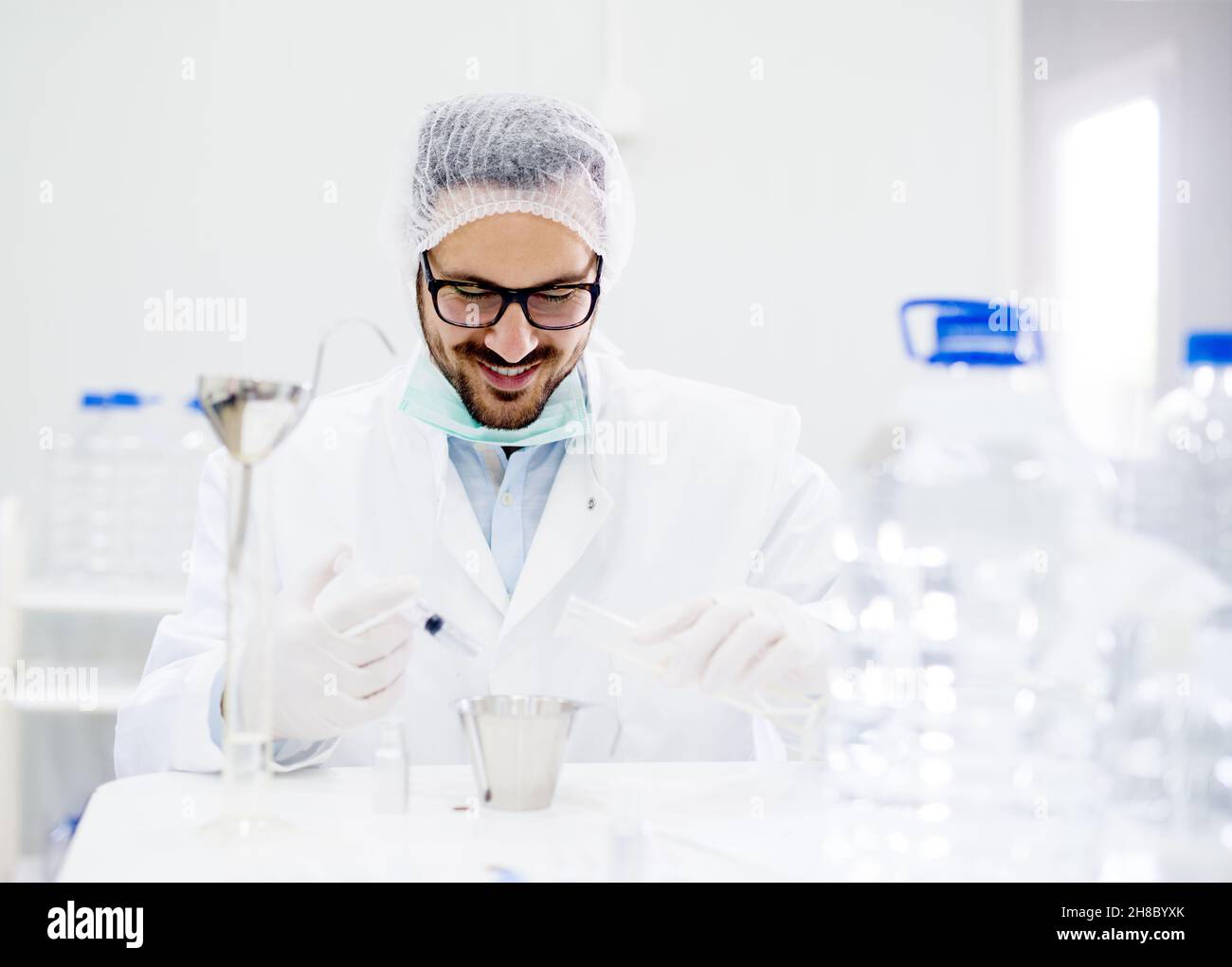 Lab technician doing chemical analysis. Testing chemical composition of ...