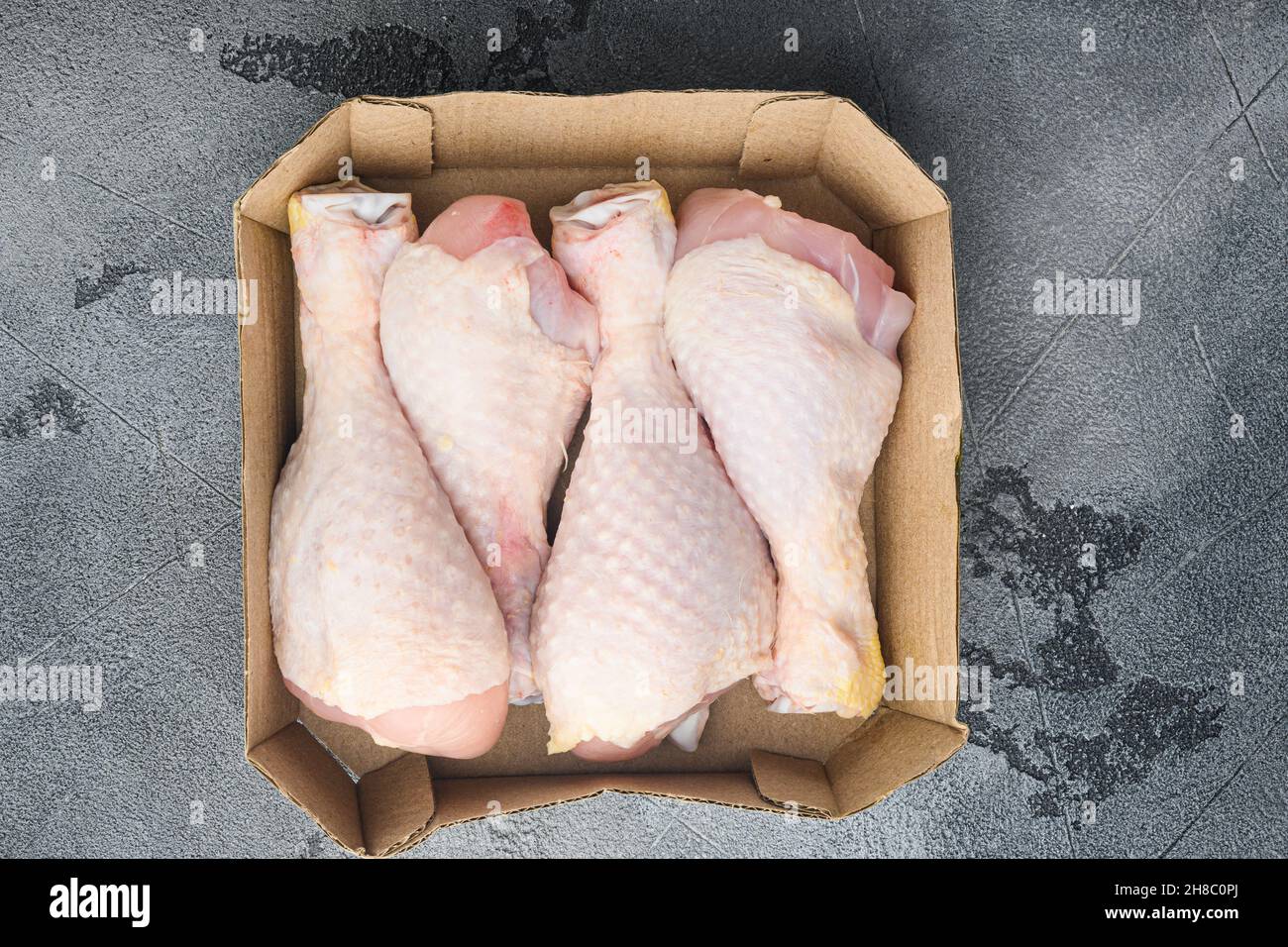Family pack of fresh chicken legs set, in paper Pack, on gray stone ...