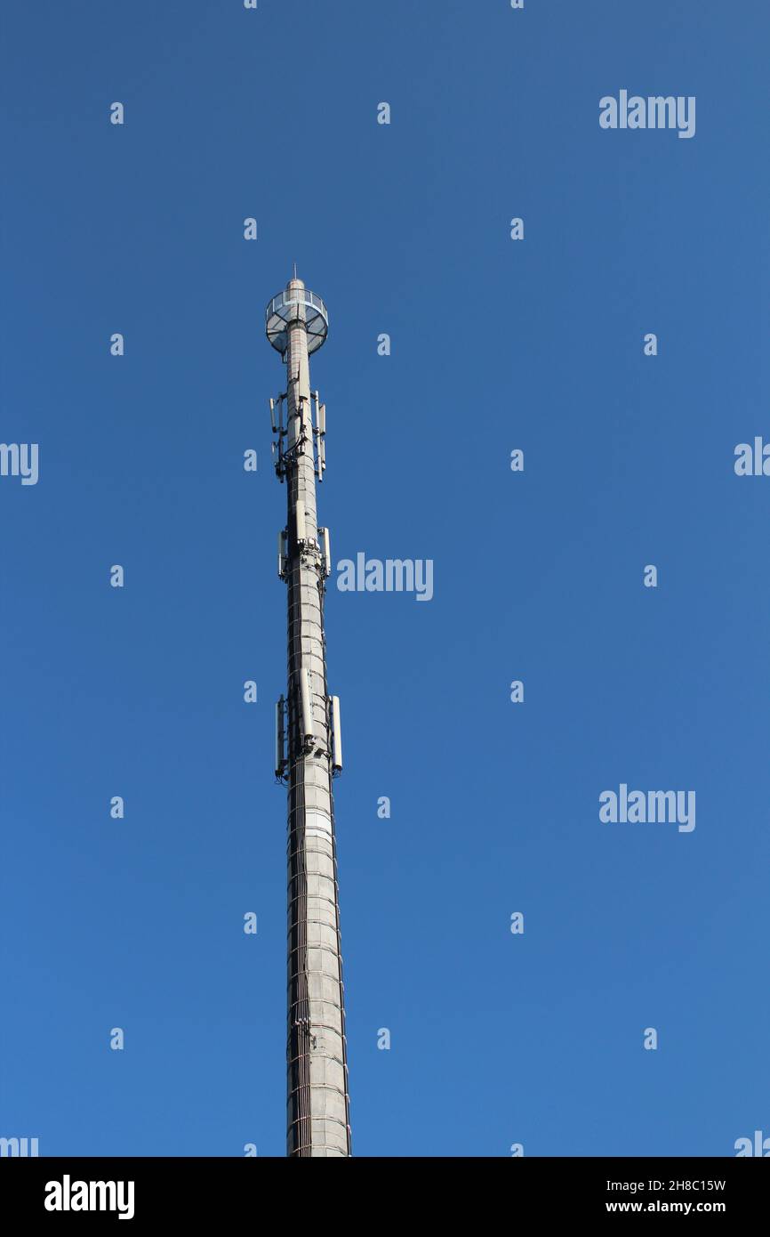 Vertical low angle view of a transmission tower under a clear blue sky ...