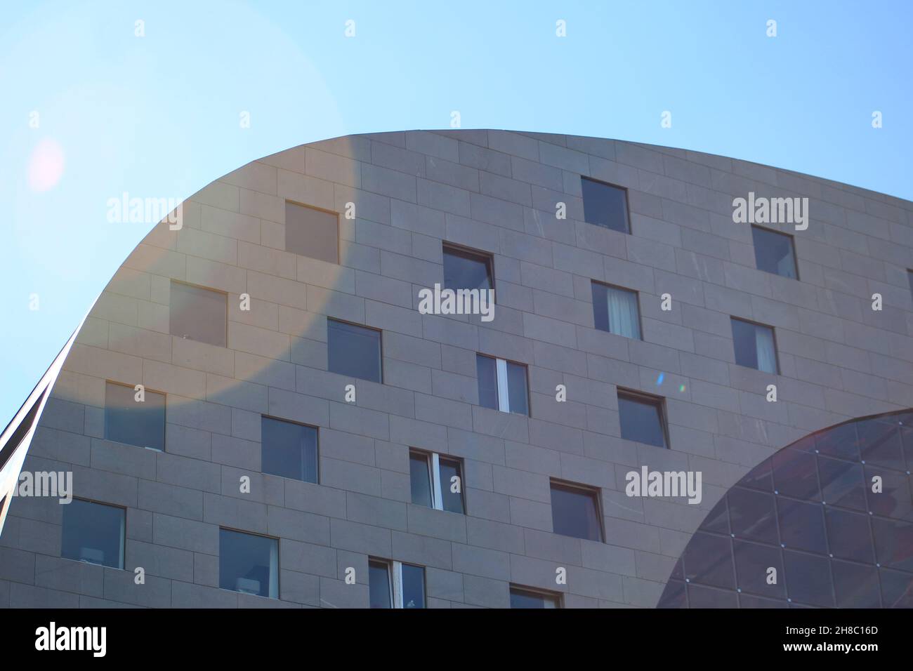 Low angle closeup of an oval shape modern facade of an interesting ...