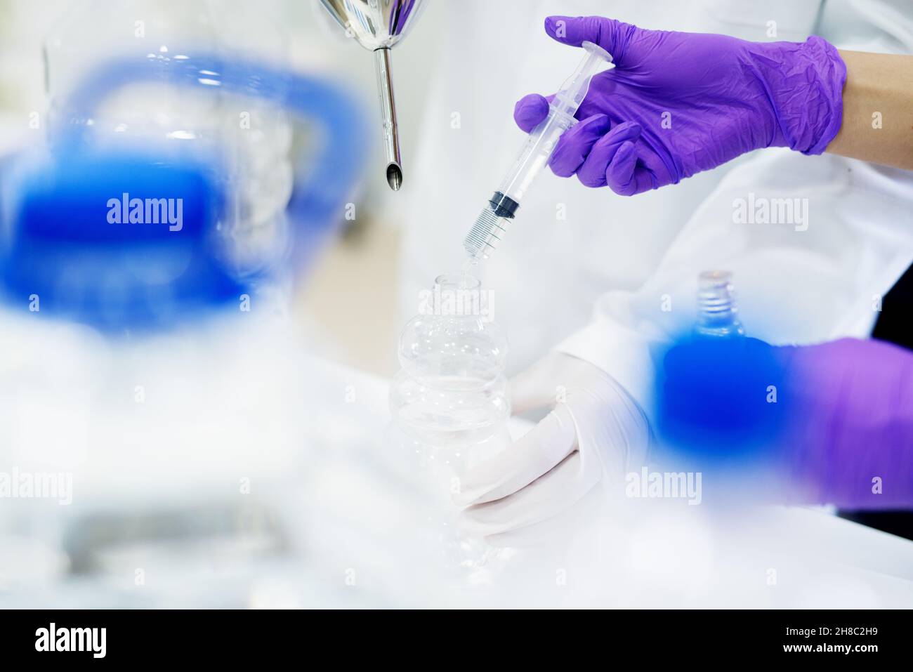 Lab technician doing chemical analysis. Testing chemical composition of ...