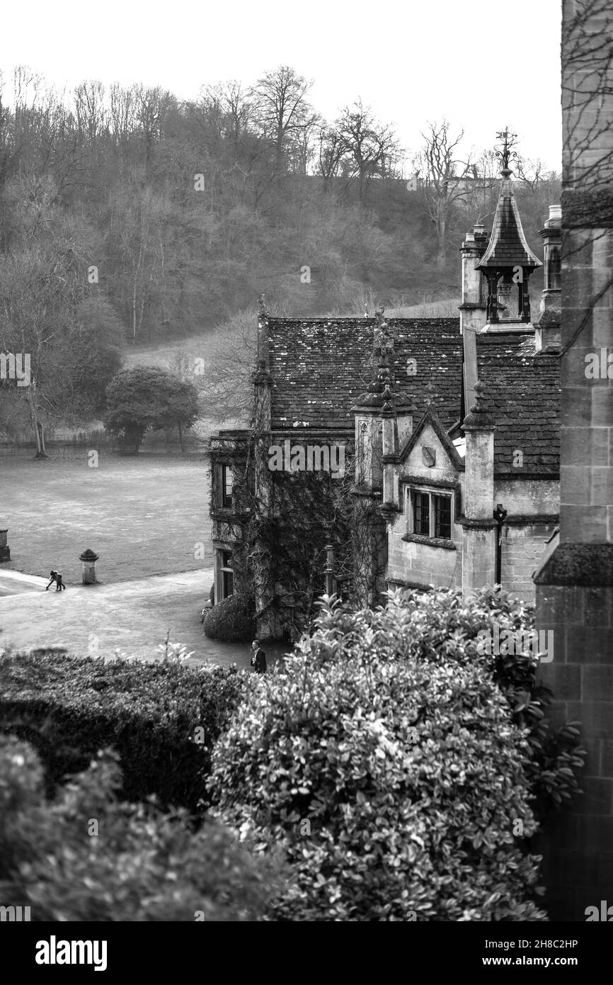 Eerie scenery of a gothic church with a graveyard in England, grayscale ...