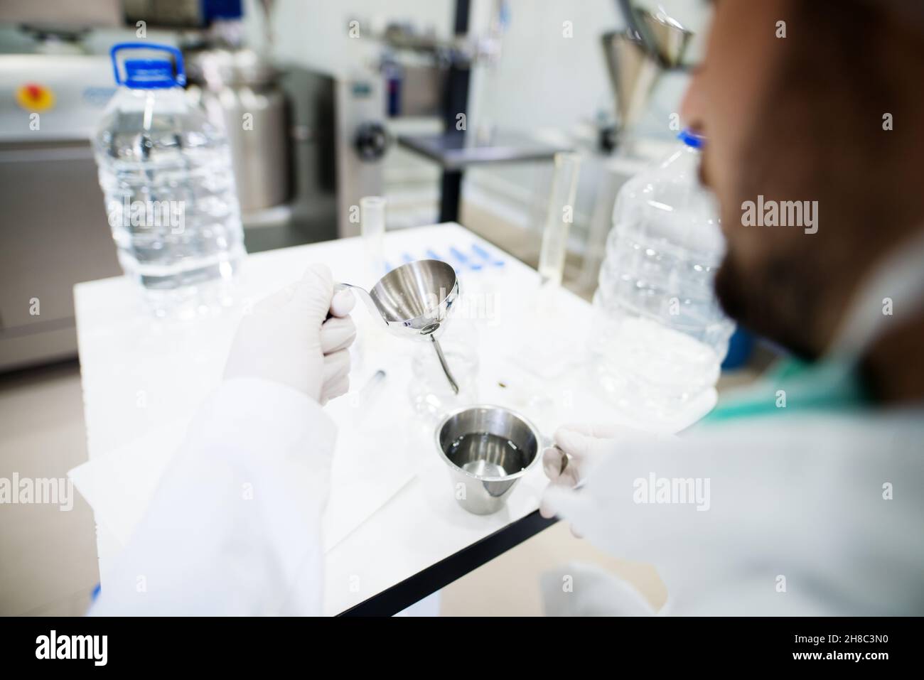 Lab technician doing chemical analysis. Testing chemical composition of ...