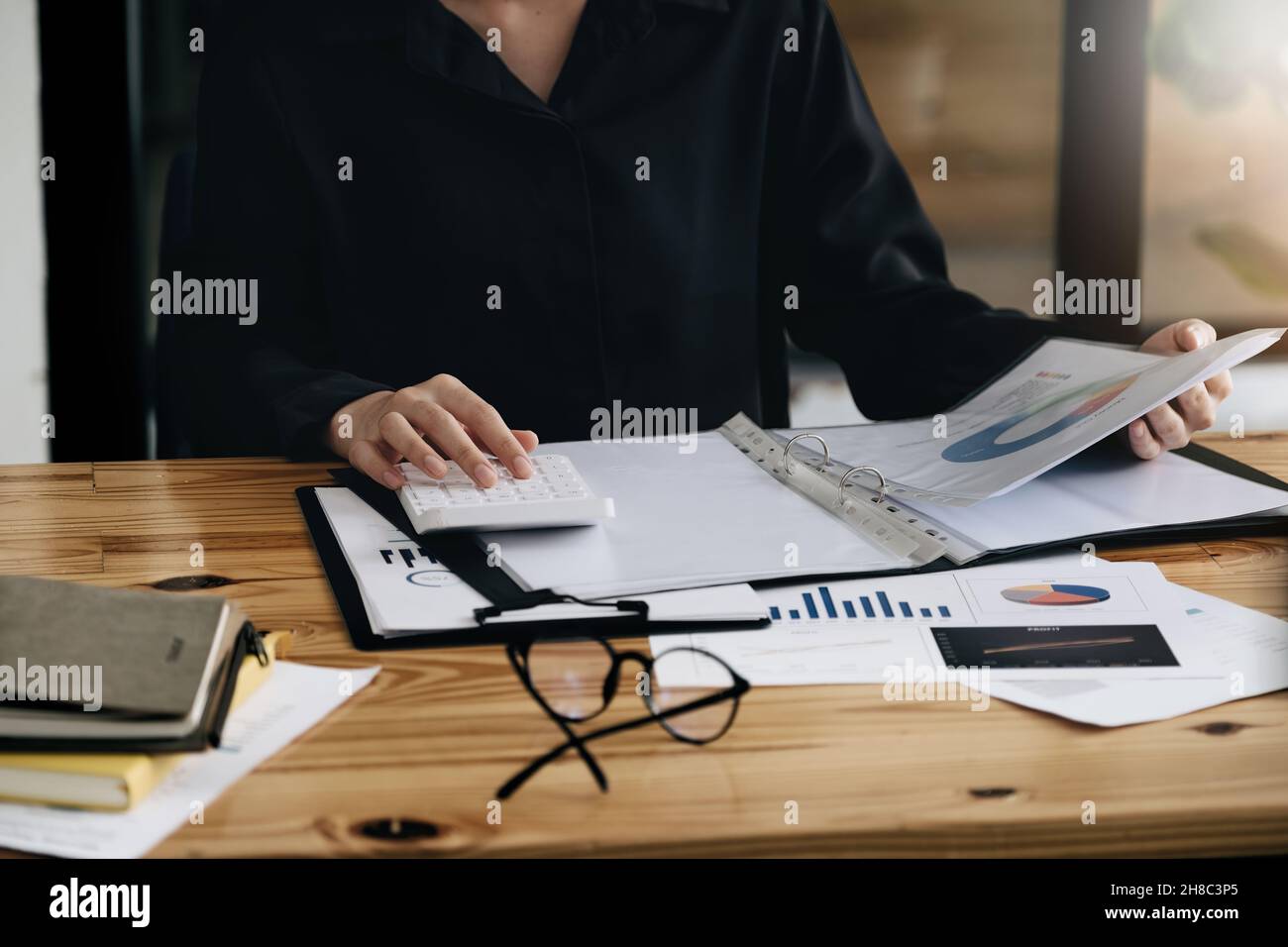 businesswoman working on desk office with using a calculator to ...
