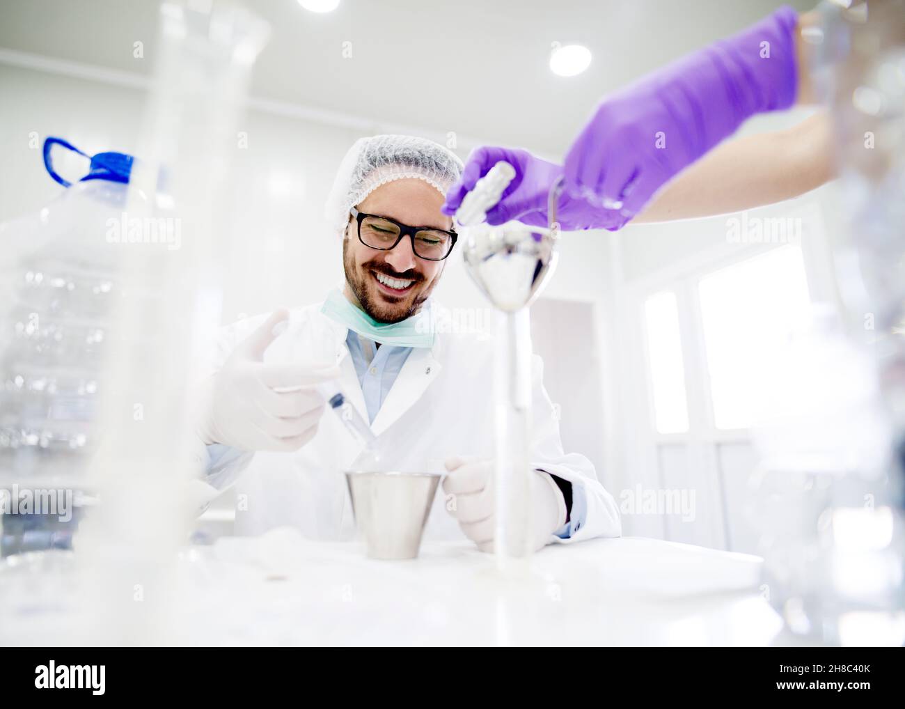 Plastic bottles production. Healthcare industry, scientist doing ...