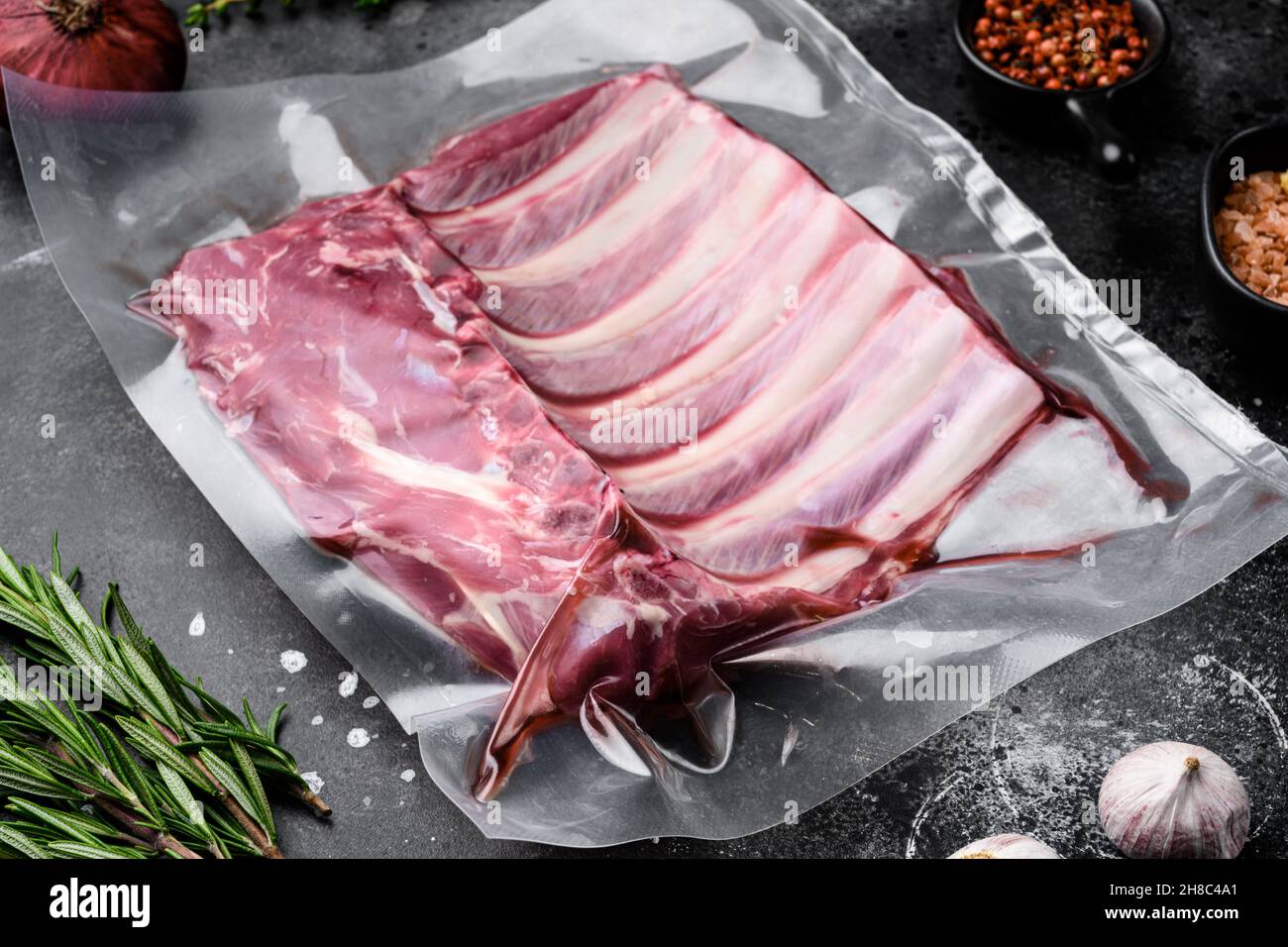 Lamb rib pack set, on black dark stone table background Stock Photo - Alamy