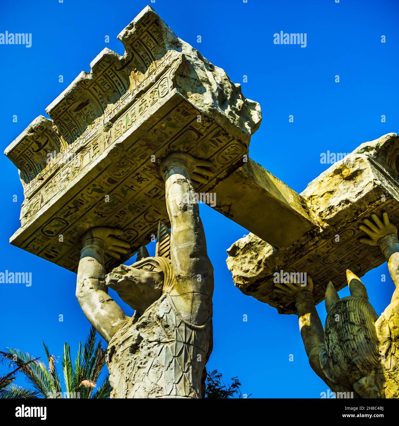 Egyptian statues lifting big boulders written with hieroglyphs at ...