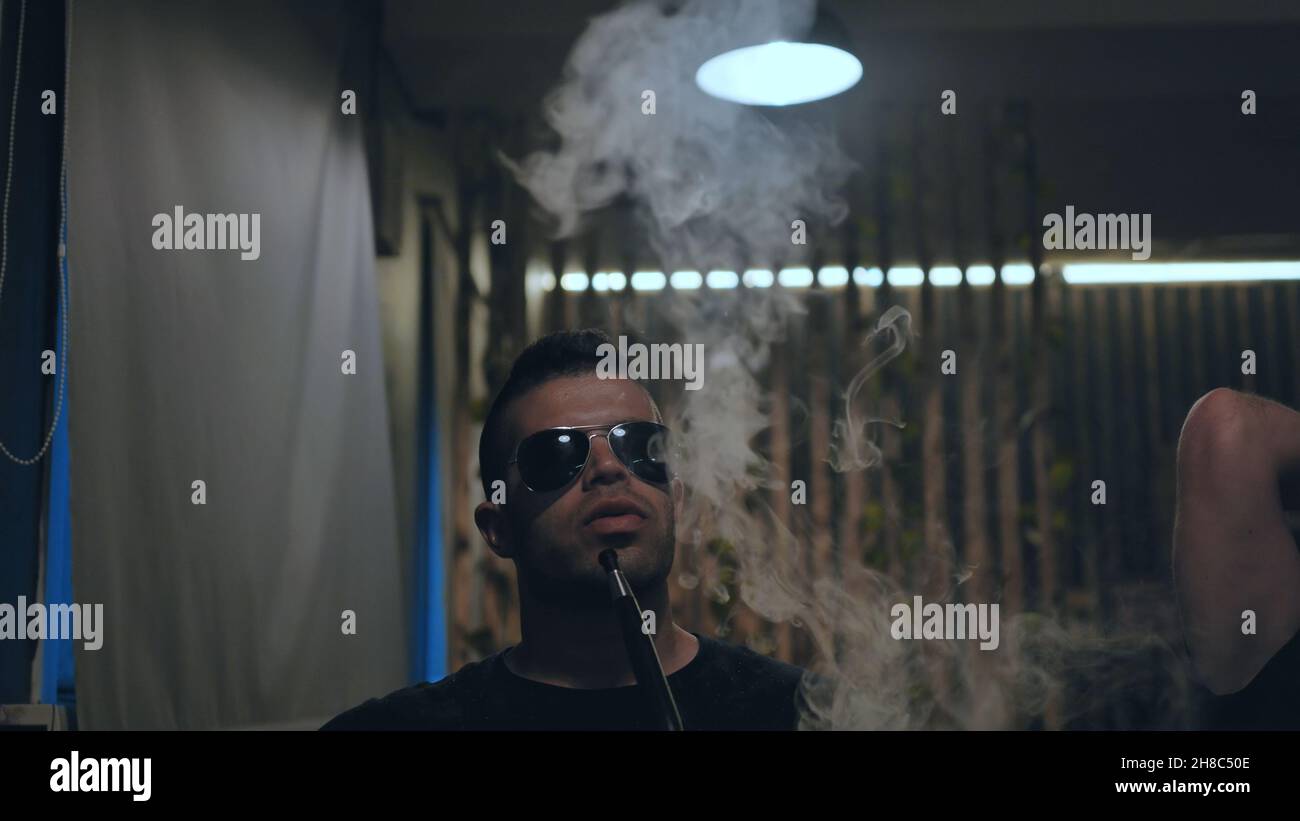 Arabic jordanian young man smokes a hookah Stock Photo - Alamy