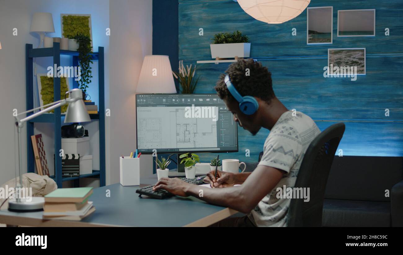 Person working with sketch of blueprint plan on computer to create ...