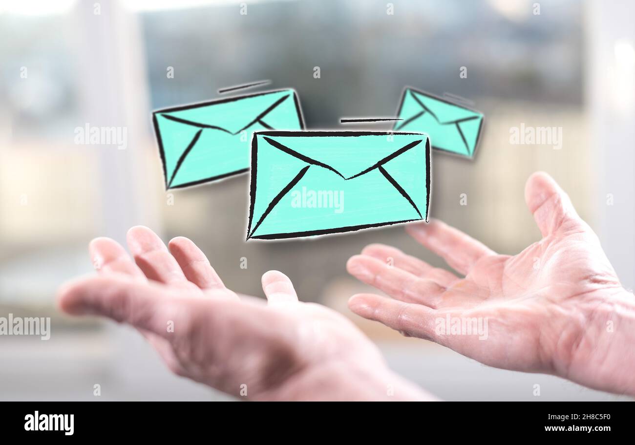 E-mail concept above the hands of a man Stock Photo - Alamy